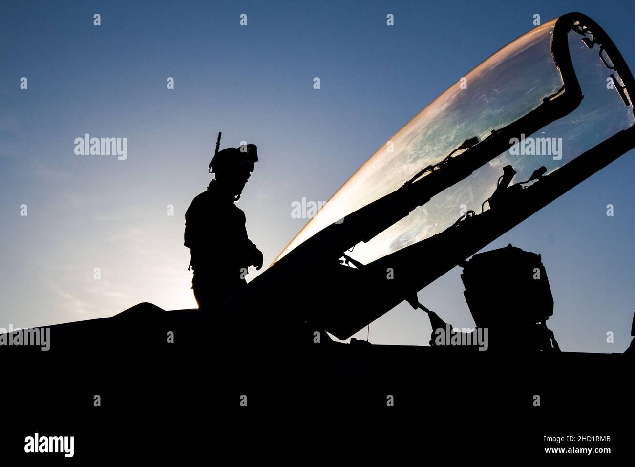 Silhouette of pilots getting into a plane on blue sky background Stock ...