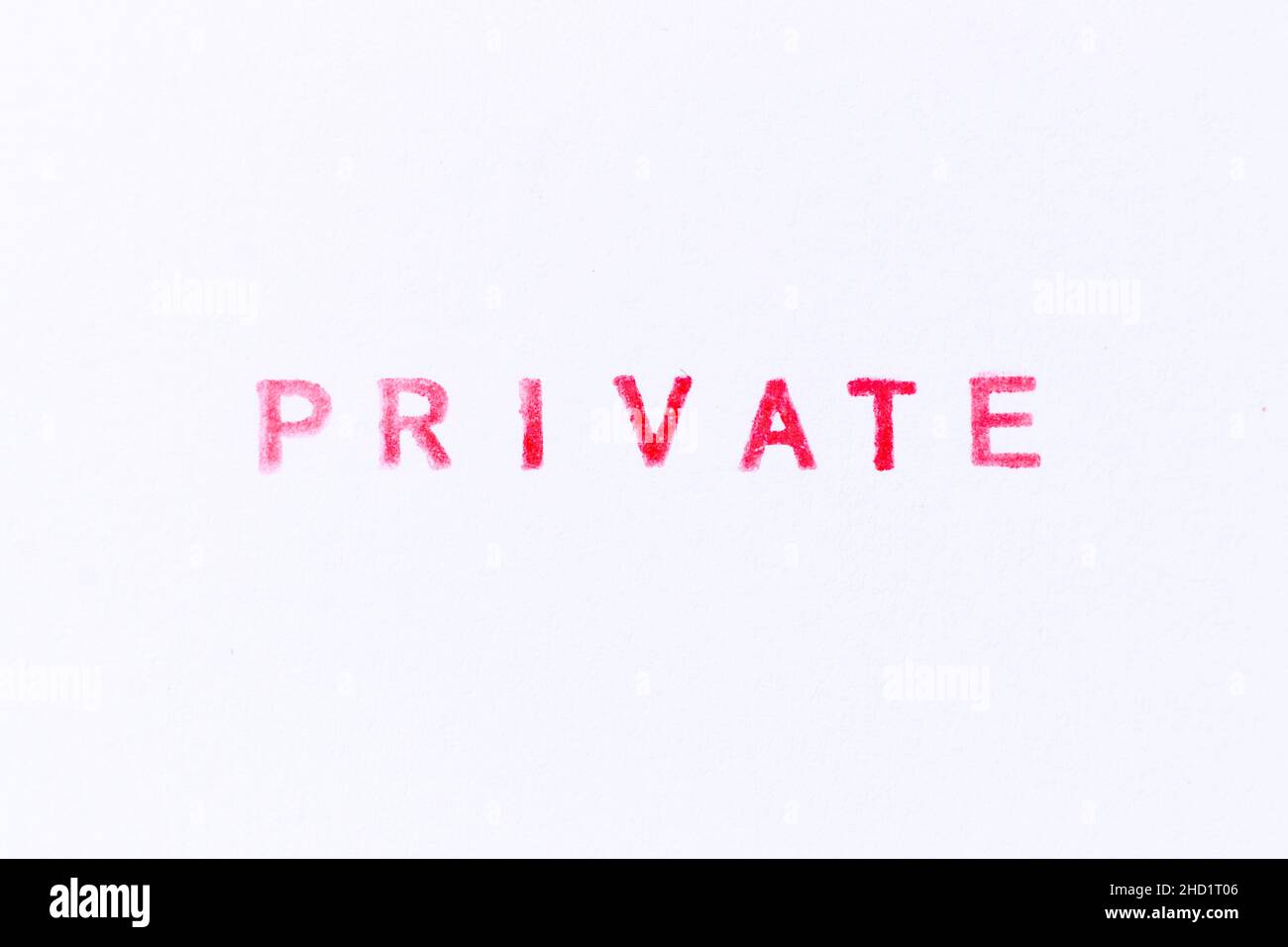 Red color ink rubber stamp in word private on white paper background ...