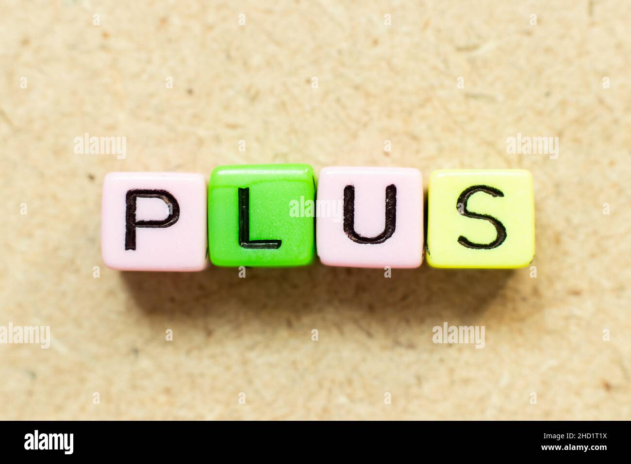 Color alphabet letter block in word plus on wood background Stock Photo ...