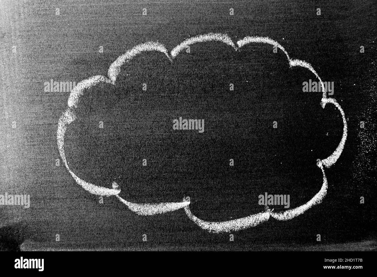 White color chalk hand drawing in cloud shape on blackboard or ...