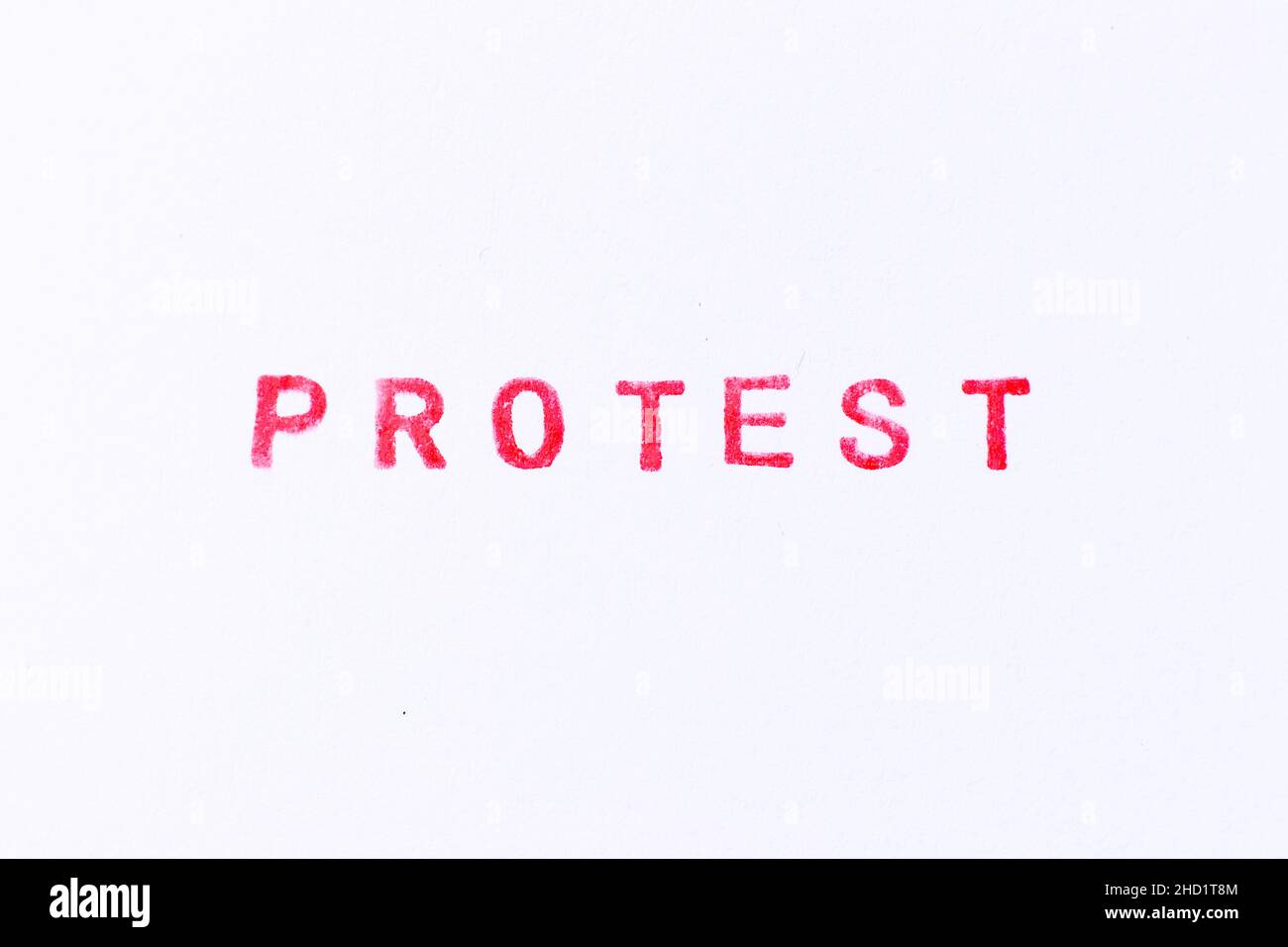 Red color ink rubber stamp in word protest on white paper background ...