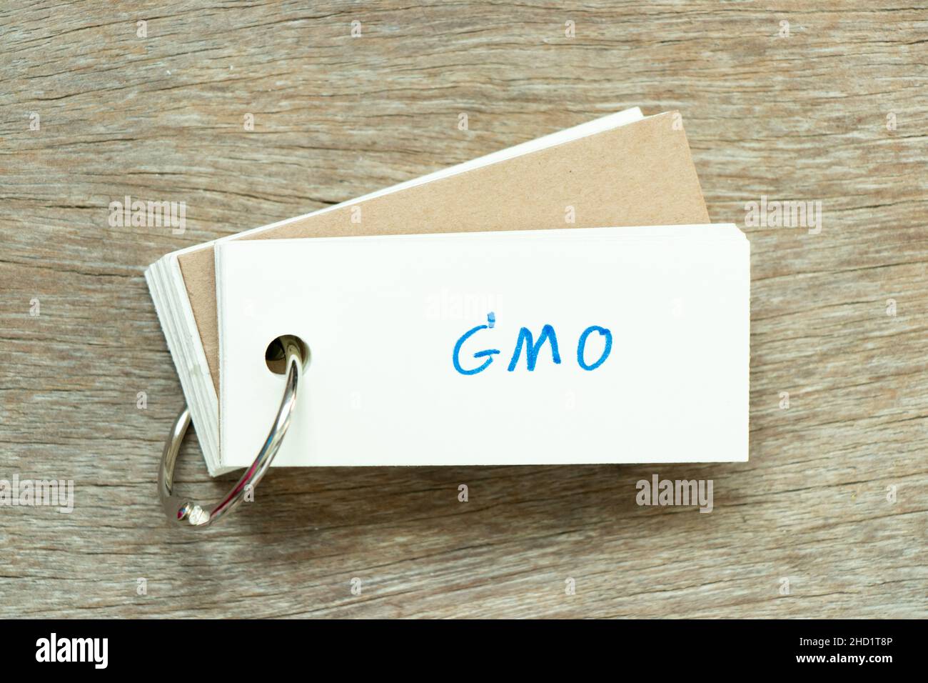 Flash card with handwriting word GMO (abbreviation of Genetically ...