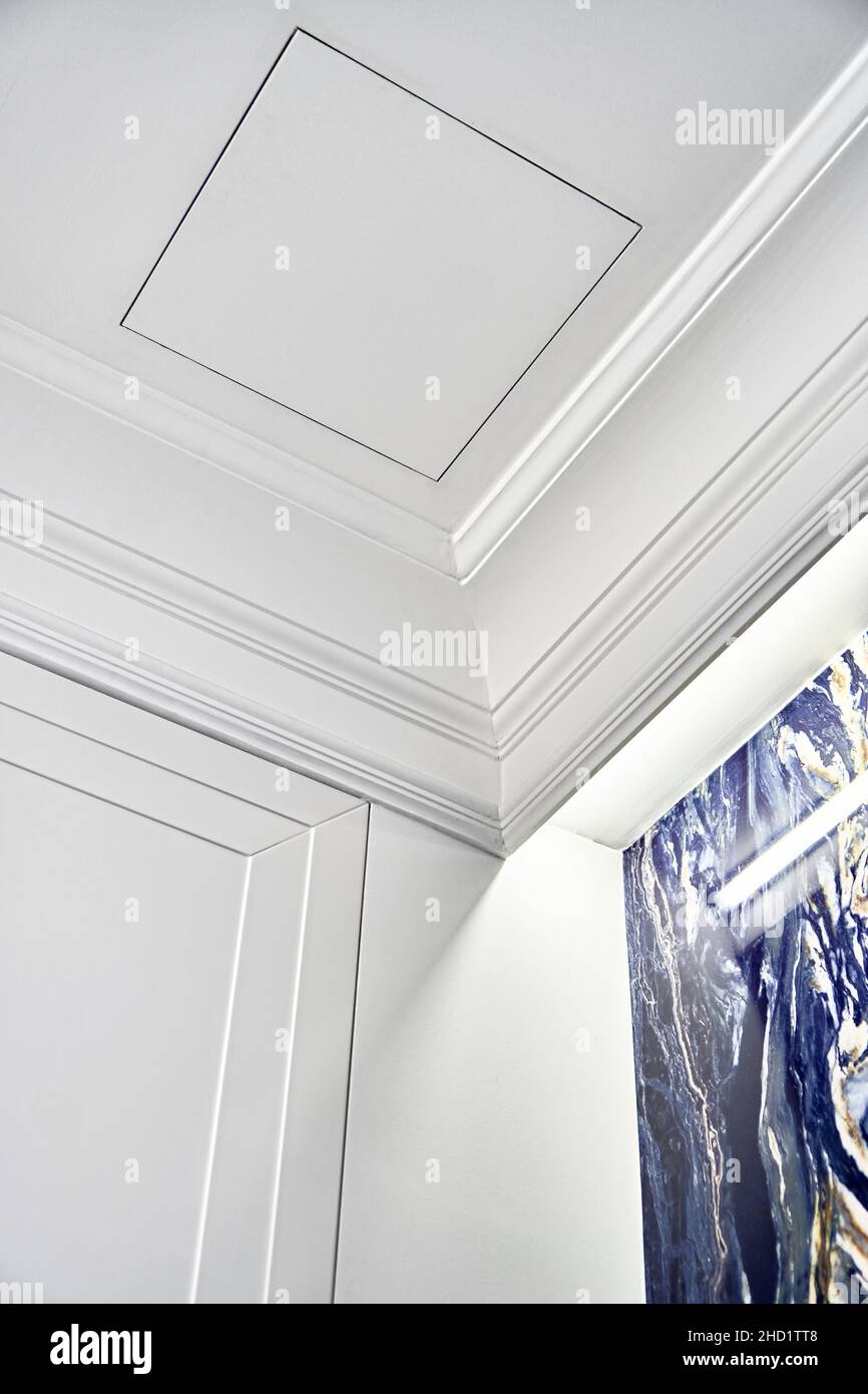 Part of elegant ceiling with LED backlight behind crown molding and ...