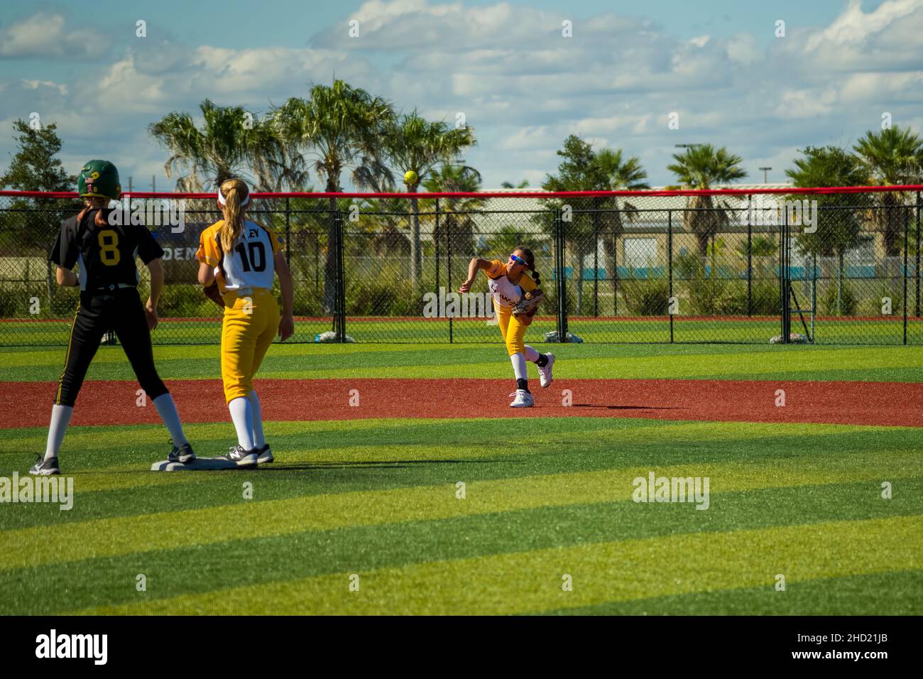 Closeup shot of females playing softball in the field in Mason in the ...