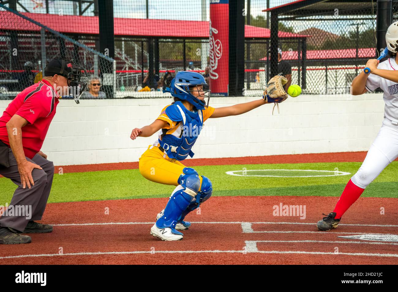 Closeup shot of females playing softball in the field in Mason in the ...