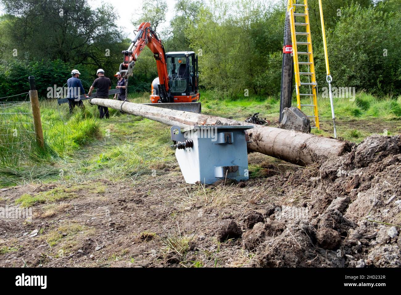 Western Power workers engineers erecting a new utility pole to connect ...