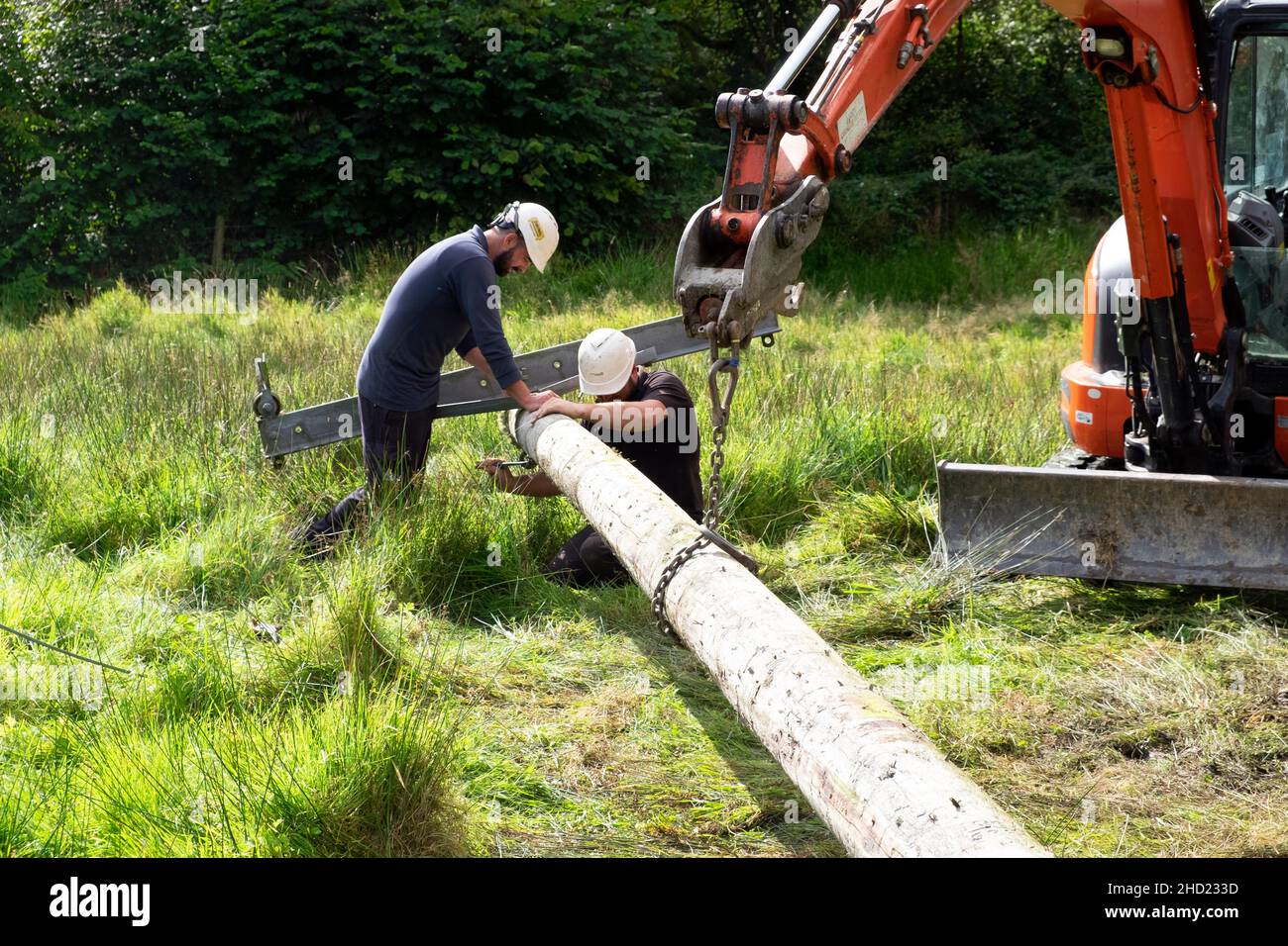 Western Power workers engineers erecting a new utility pole to connect ...