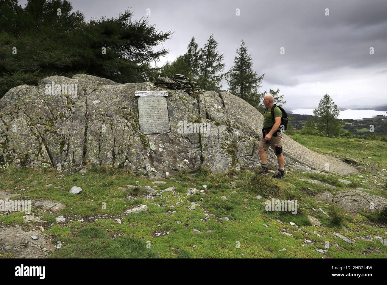 Walker at the summit cairn on Castle Crag fell above the Borrowdale ...