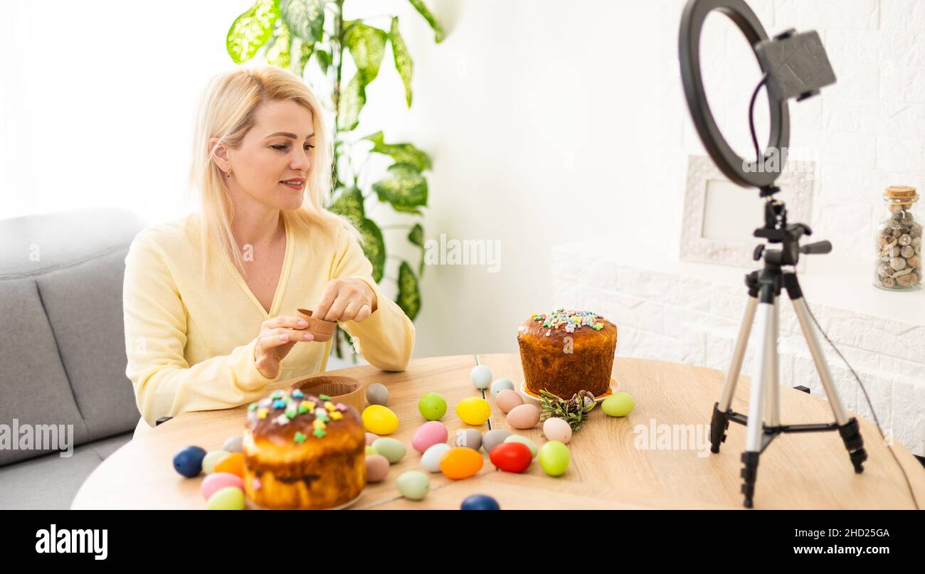 A young woman conducts an online master class on decorating Easter eggs ...