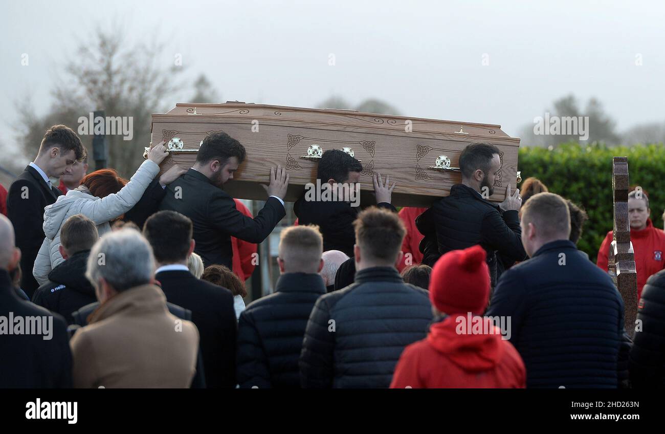 Family members hold onto the coffin of Nathan Corrigan, 20, as it is ...