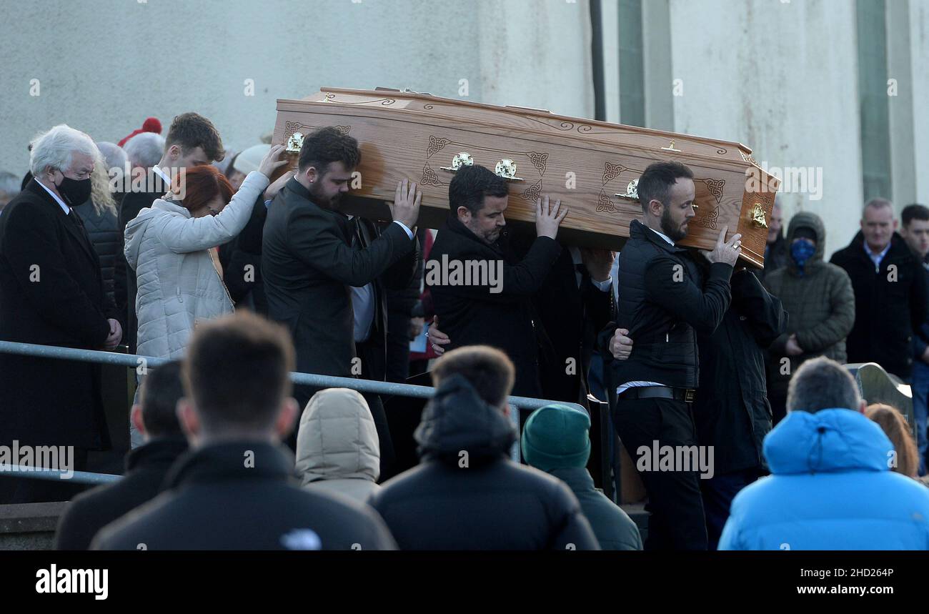 Family members hold onto the coffin of Nathan Corrigan, 20, as it is ...
