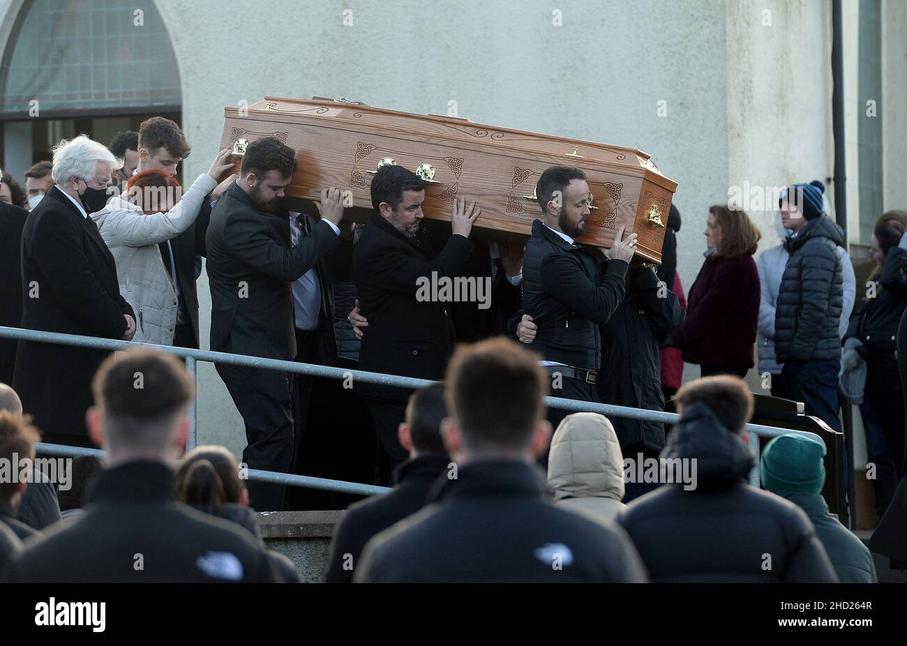Family members hold onto the coffin of Nathan Corrigan, 20, as it is ...