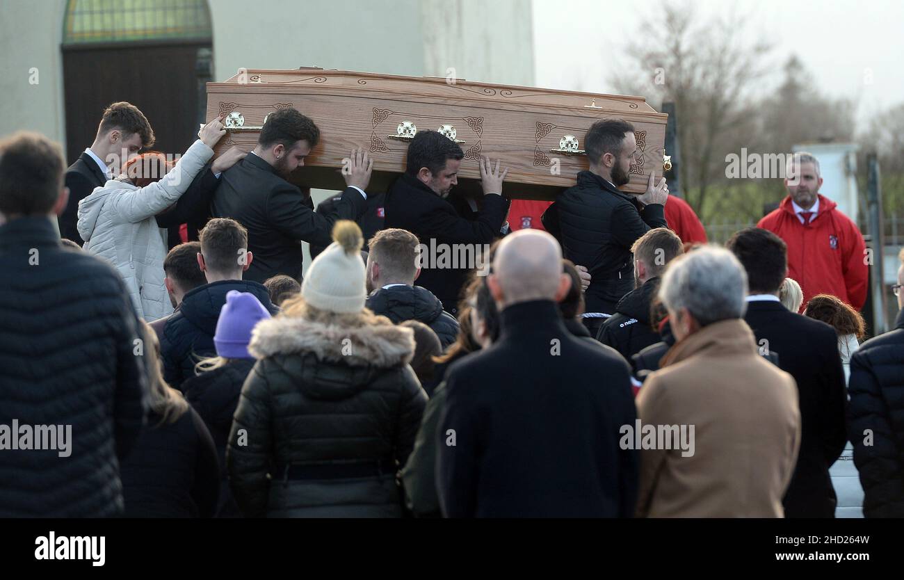 Family members hold onto the coffin of Nathan Corrigan, 20, as it is ...