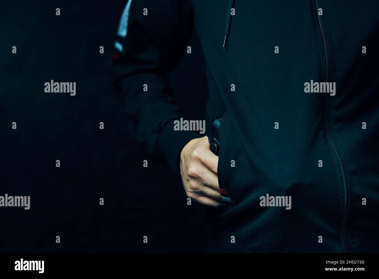 Guy is threatening with gun in his jacket pocket Stock Photo - Alamy