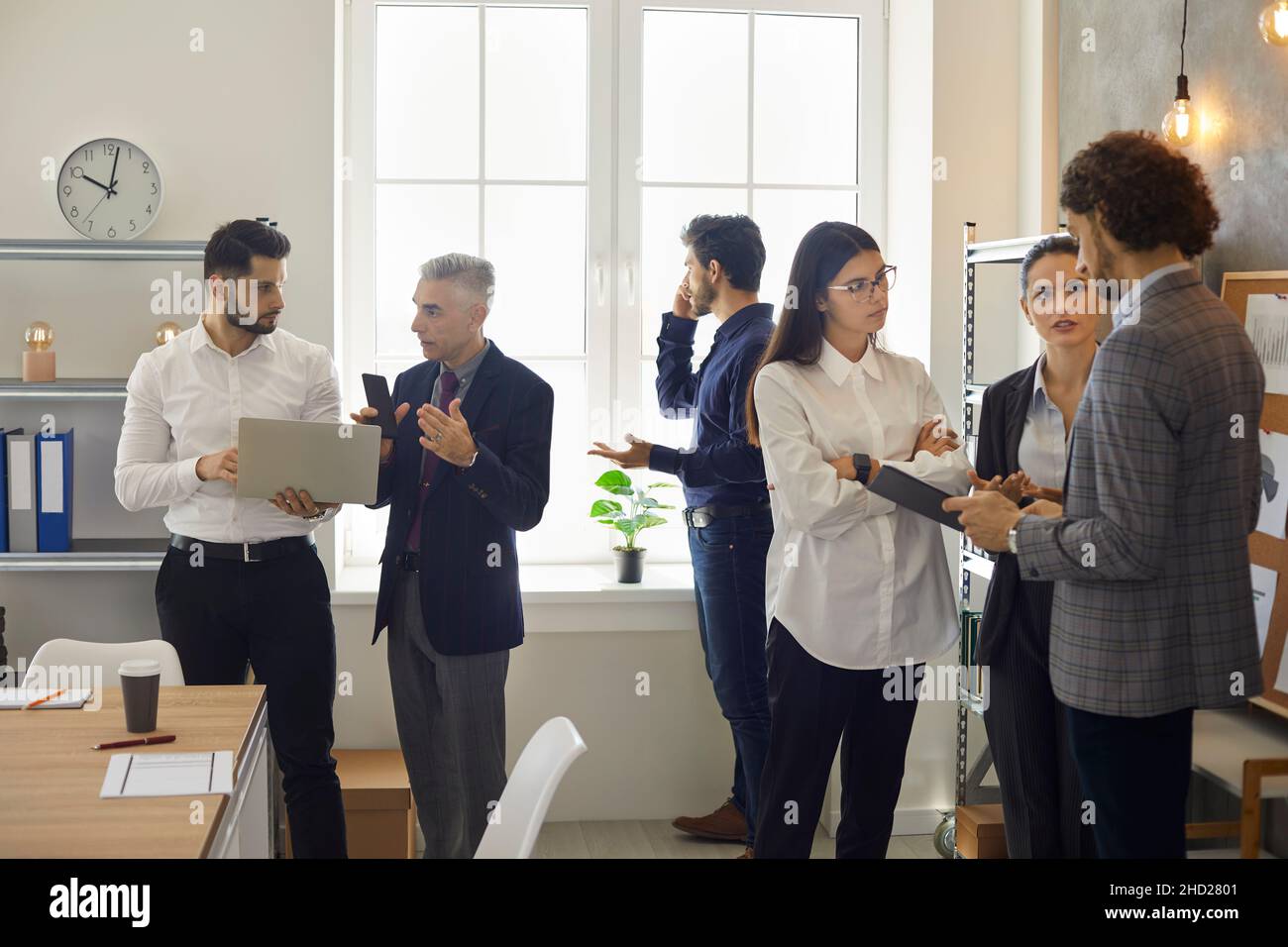 Group of office workers work and solve various issues in a modern ...