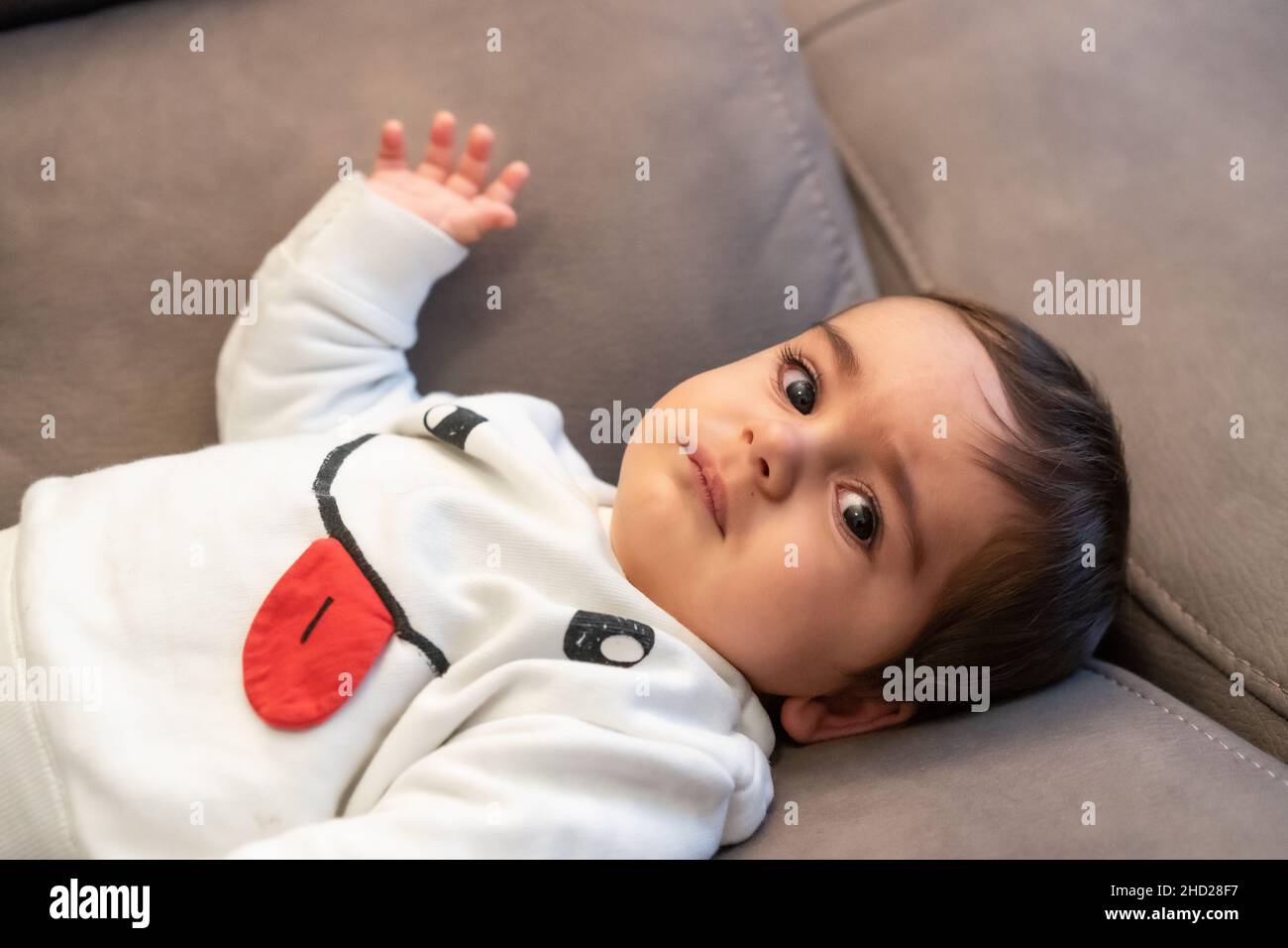 Baby crying with the pain of his first teeth Stock Photo - Alamy