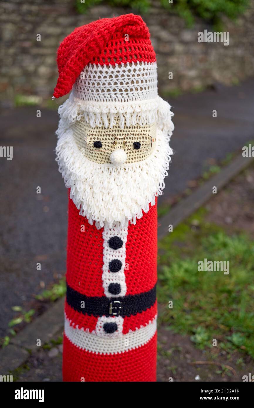 Knitted Father Christmas decoration on a bollard in Pentyrch, South ...