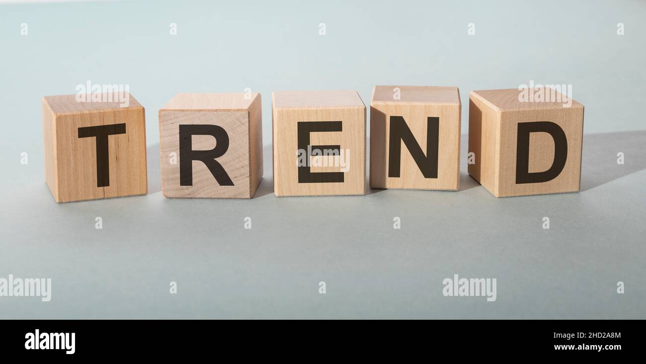 Trend word on cubes with grey background Stock Photo - Alamy