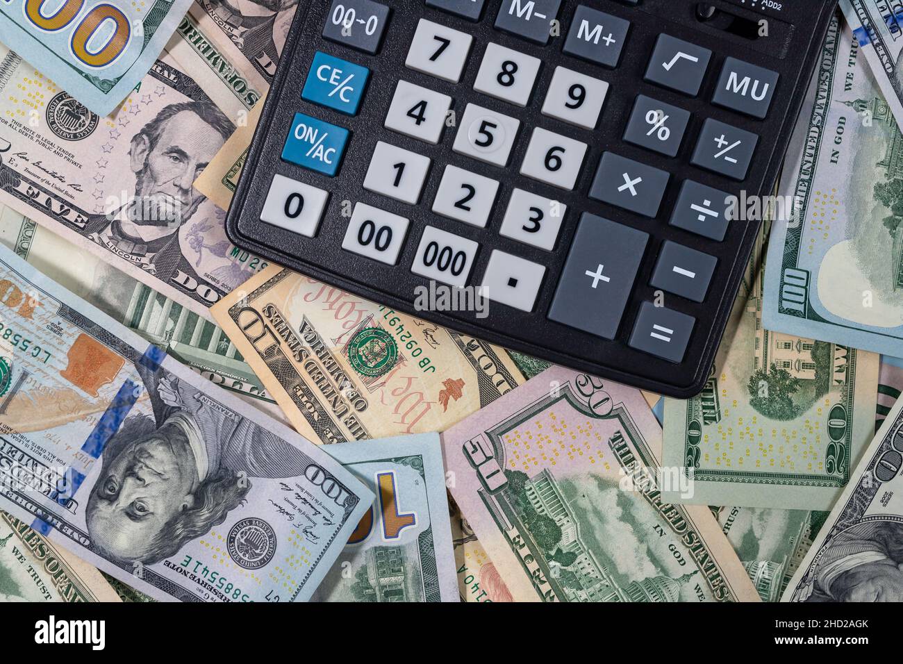 calculator lies on a scattered pile of us dollars. Finance and economic ...