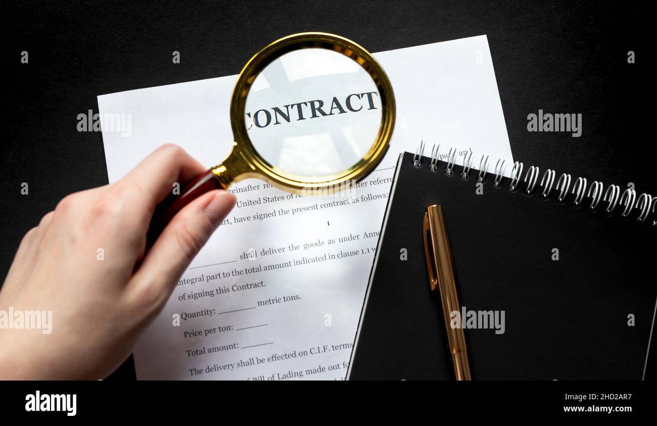 Looking At CONTRACT Through Magnifying Glass loupe on black background ...