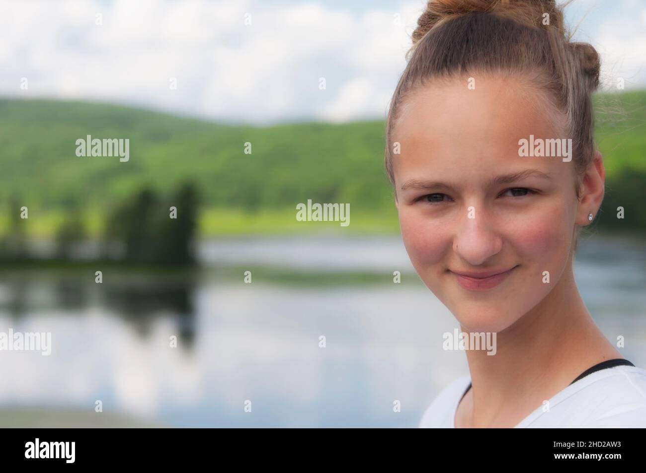 A happy teenage girl with a blurred background of hall meadow brook ...