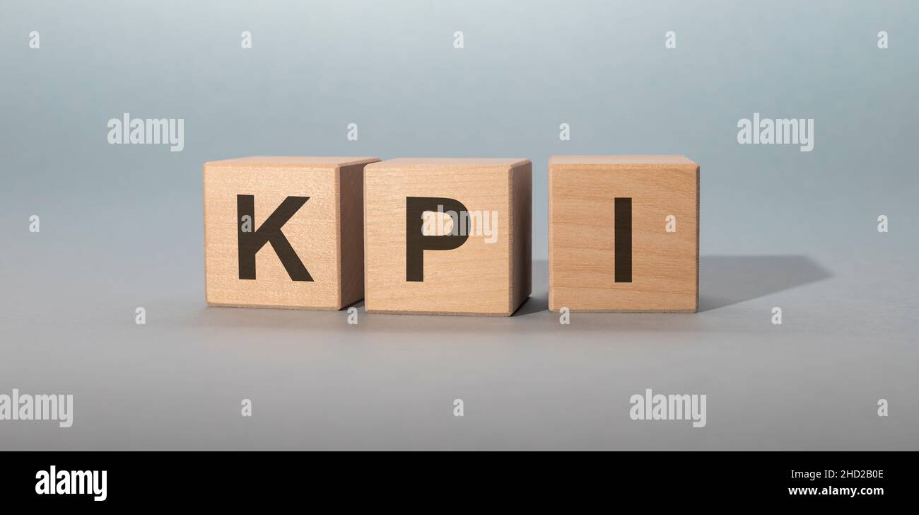 Acronym KPI - key performance indicator. Wooden cubes with letters ...