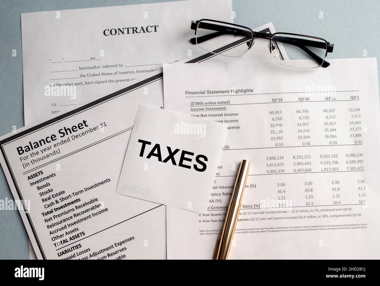 Word "Taxes"on sticker with pen glasses on documents. Tax time. Tax ...