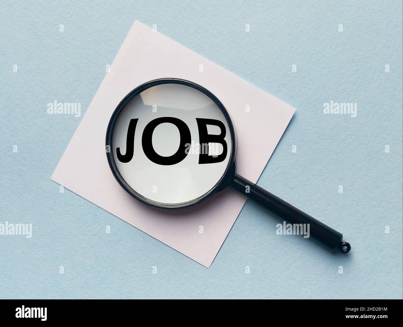 JOB word on a sticker under the loupe magnifier on blue background ...