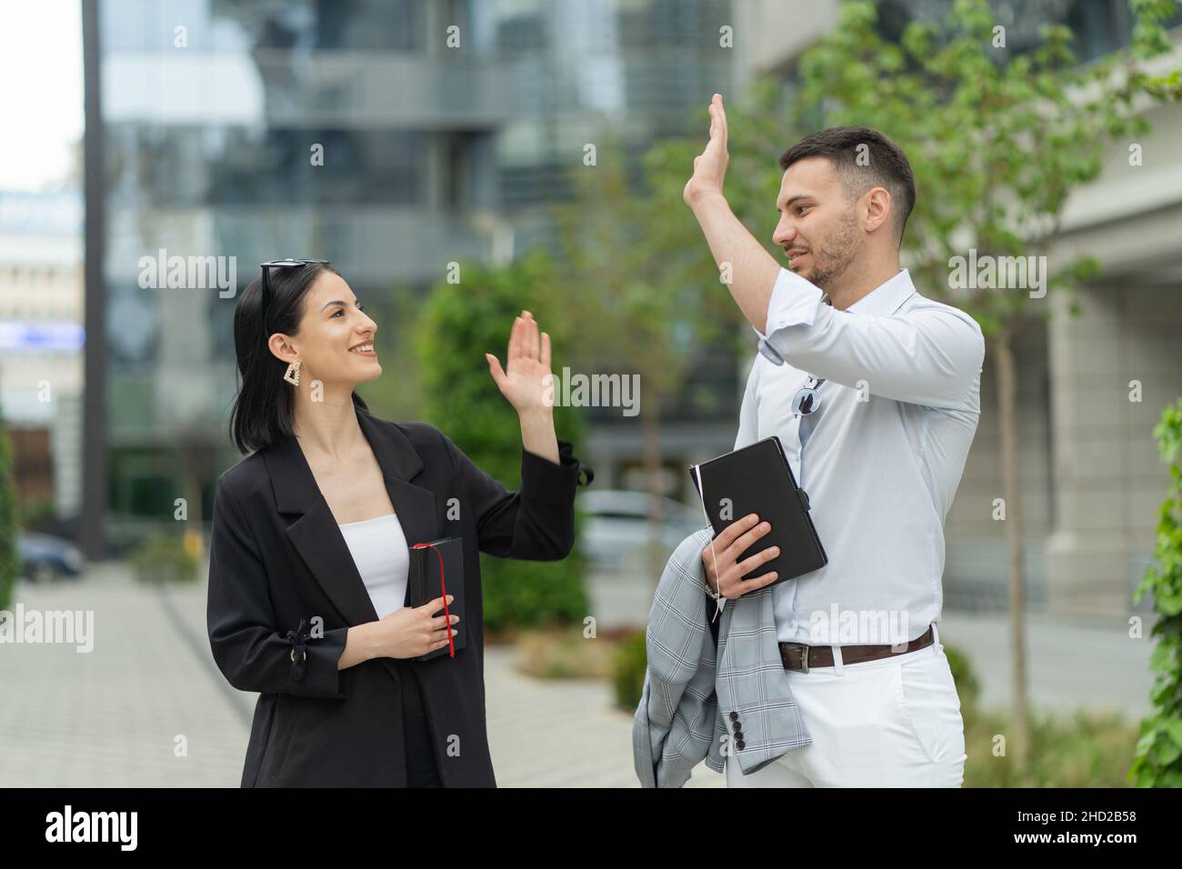 Business partners are giving each other high five Stock Photo - Alamy