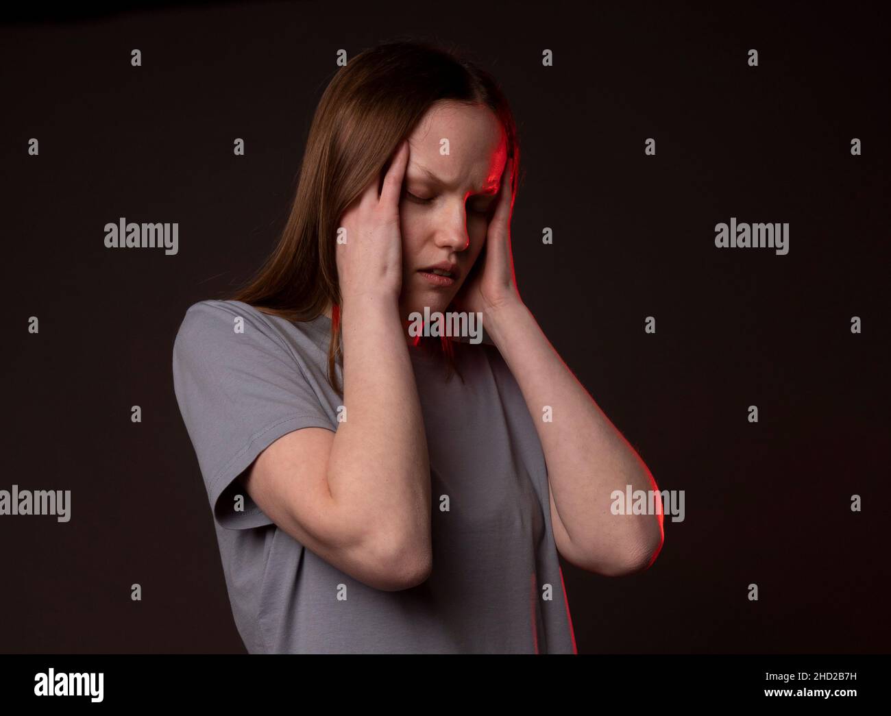 Young woman with heavy sharp headache, holding her temples with pain ...