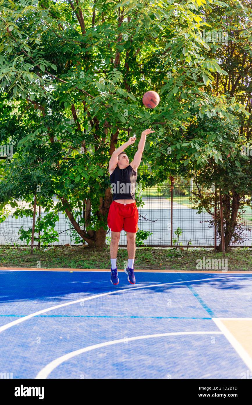 Basketball player jump shooting and playing basketball Stock Photo - Alamy