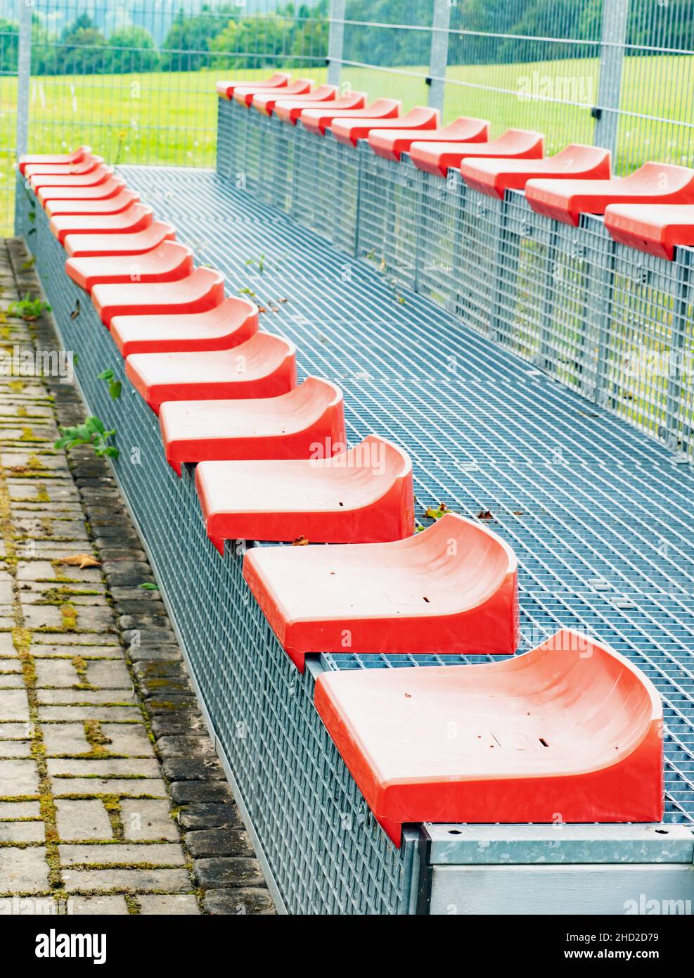 Red stadium seats, side view. Outdoor playfield tribune Stock Photo - Alamy