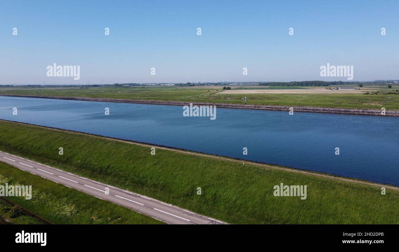 Aerial view on green polders, meadows and water transportion channel in ...