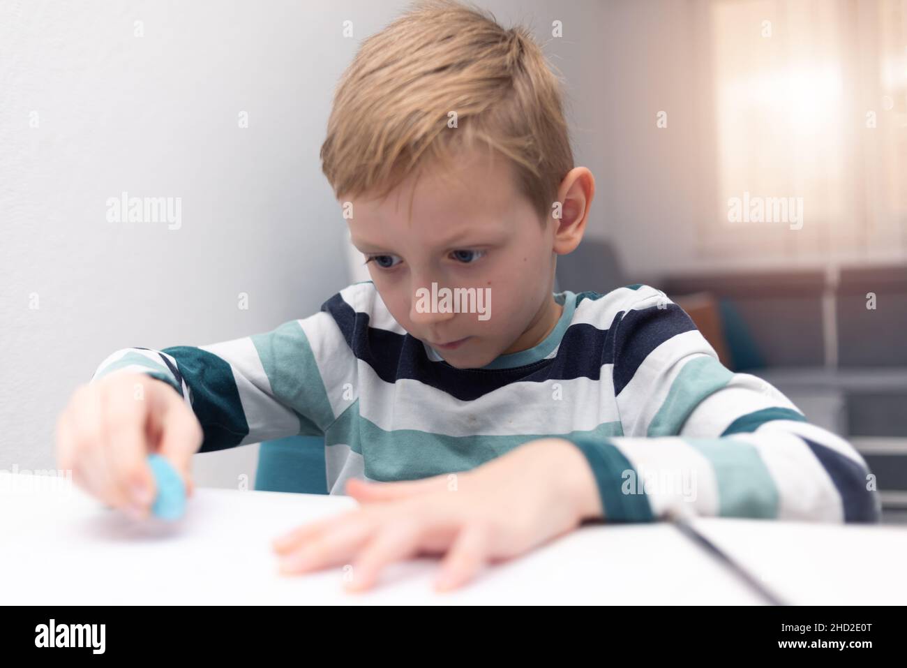 School boy practicing writing the alphabet at home. Boy child kid ...
