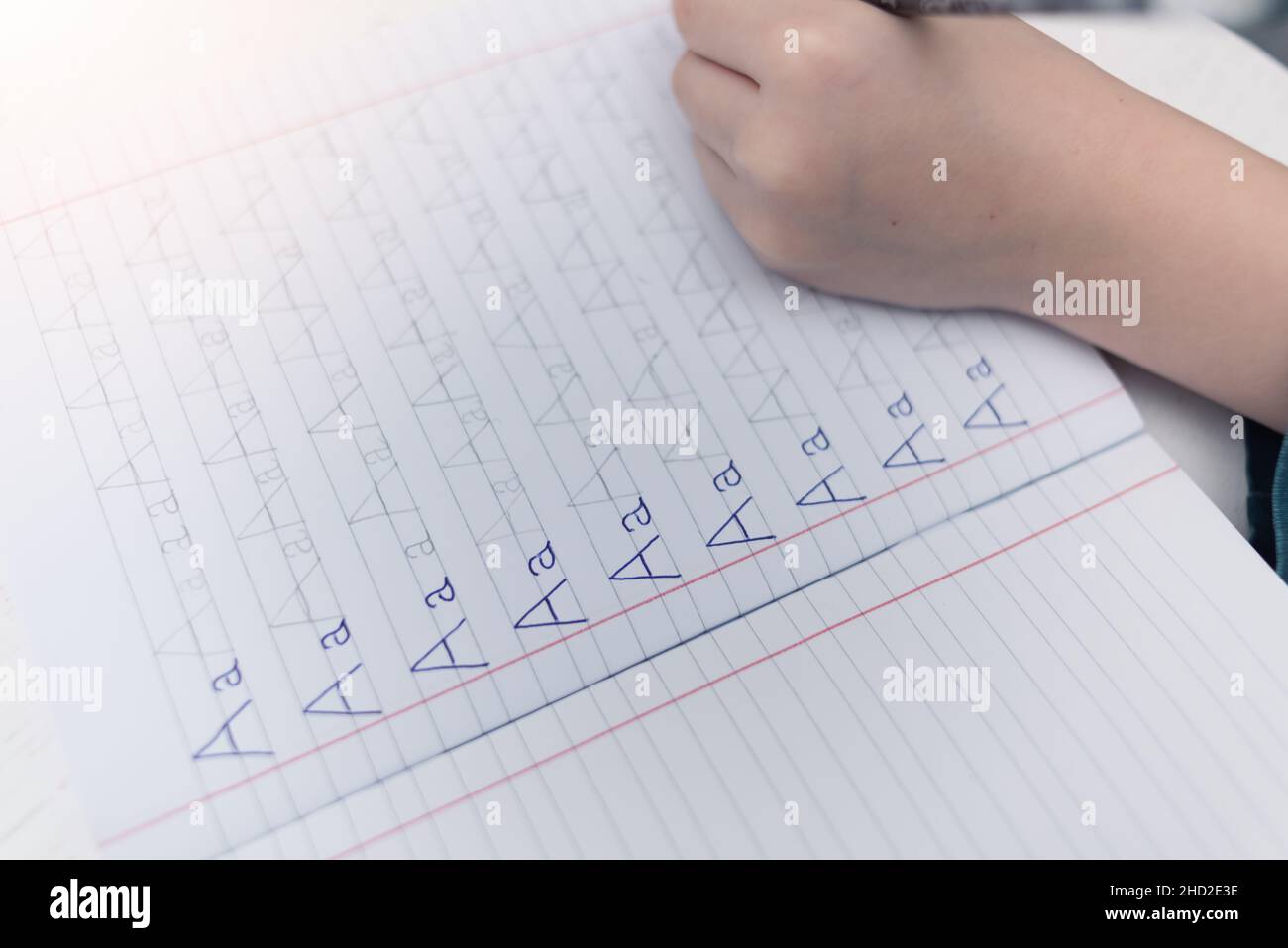 School boy practicing writing the alphabet at home. Boy child kid ...