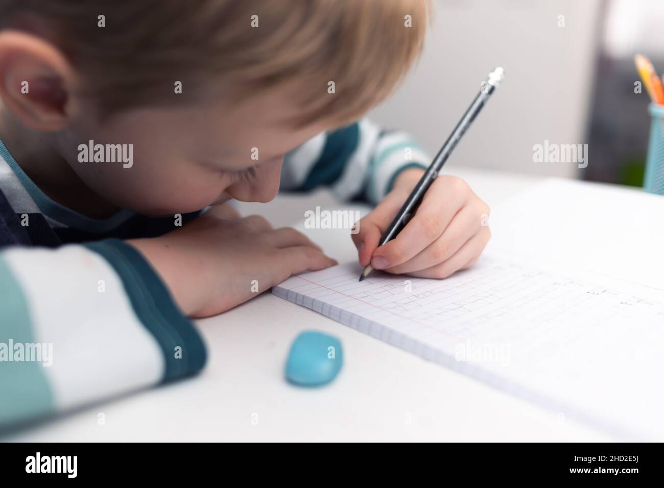 School boy practicing writing the alphabet at home. Boy child kid ...