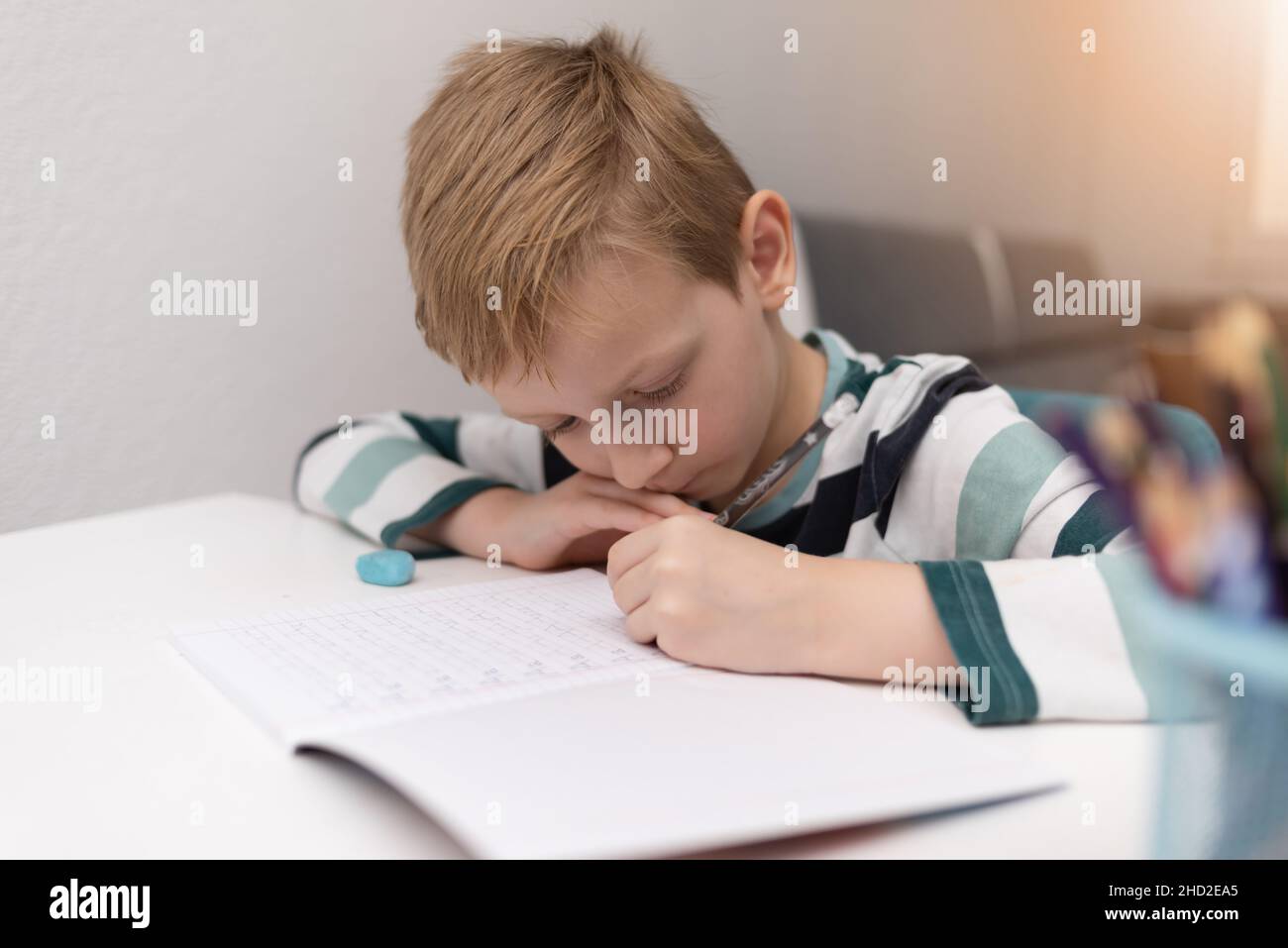 School boy practicing writing the alphabet at home. Boy child kid ...