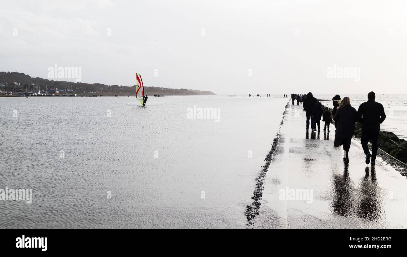 Walkers on New Years day in 2022 walking around the edge of the Marine ...