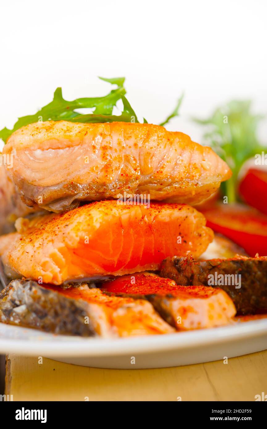 grilled fresh samon filet with vegetables salad tomato arugula ...