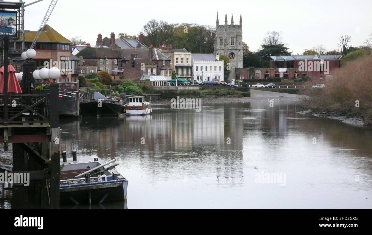 All Saints Church and riverboats on the River Thames at Old Isleworth ...