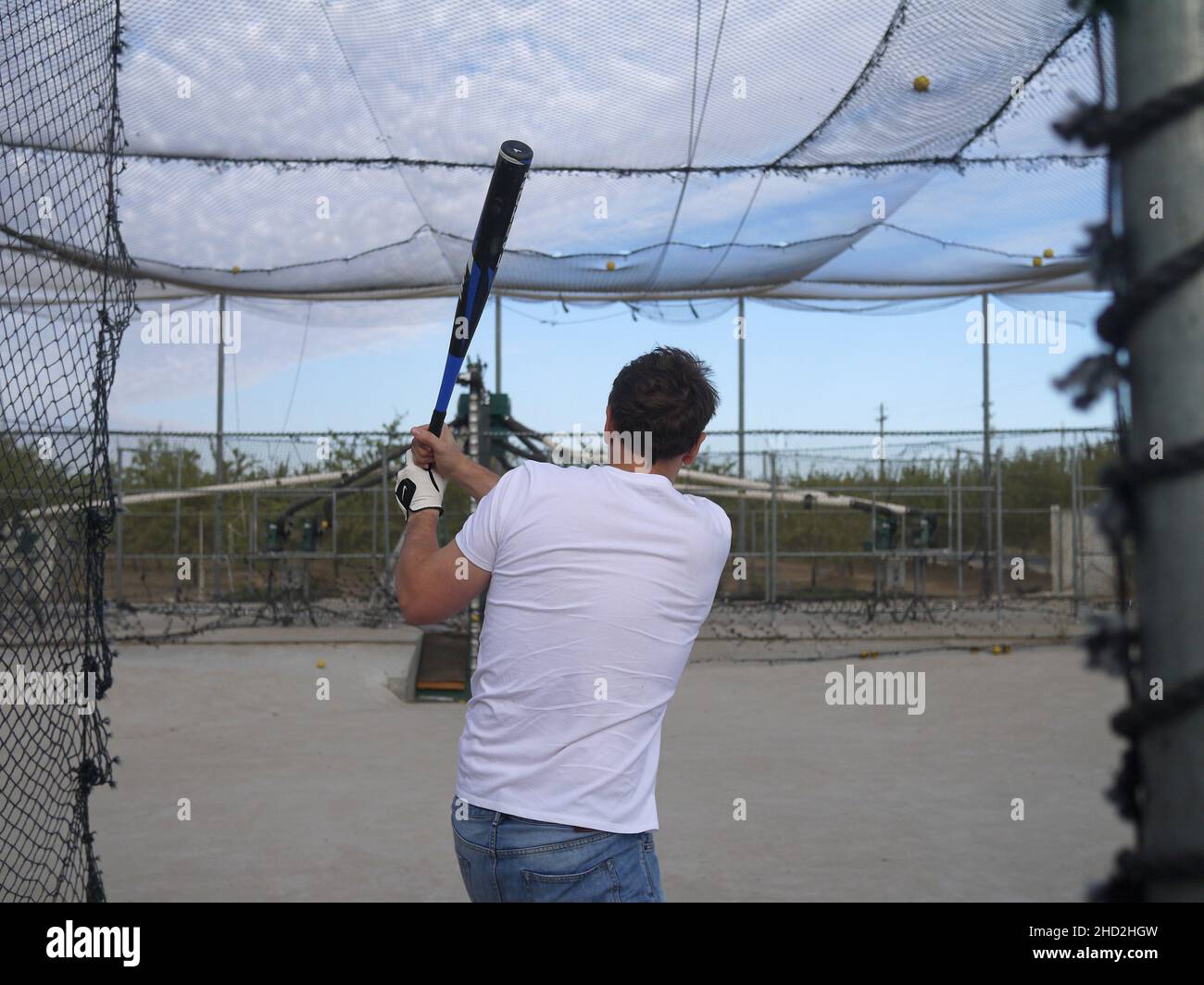 Man practicing with a baseball bat Stock Photo - Alamy