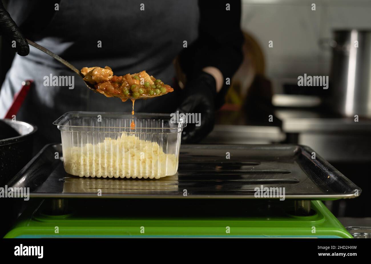 food delivery in the restaurant. Close-up of a gloved chef's hand ...