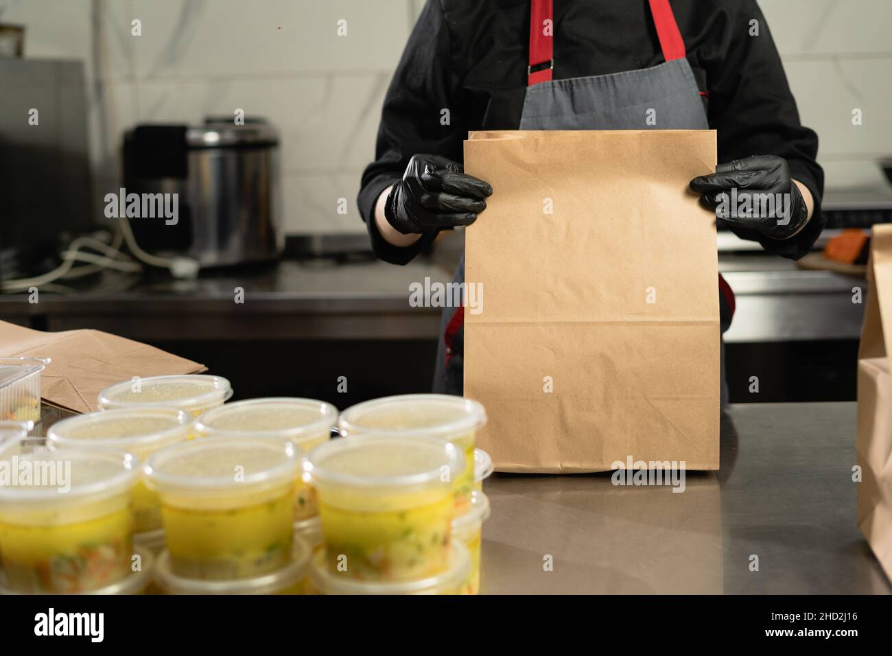 close-up, volunteers packing free hot lunches in the Poor Lunch Boxes ...
