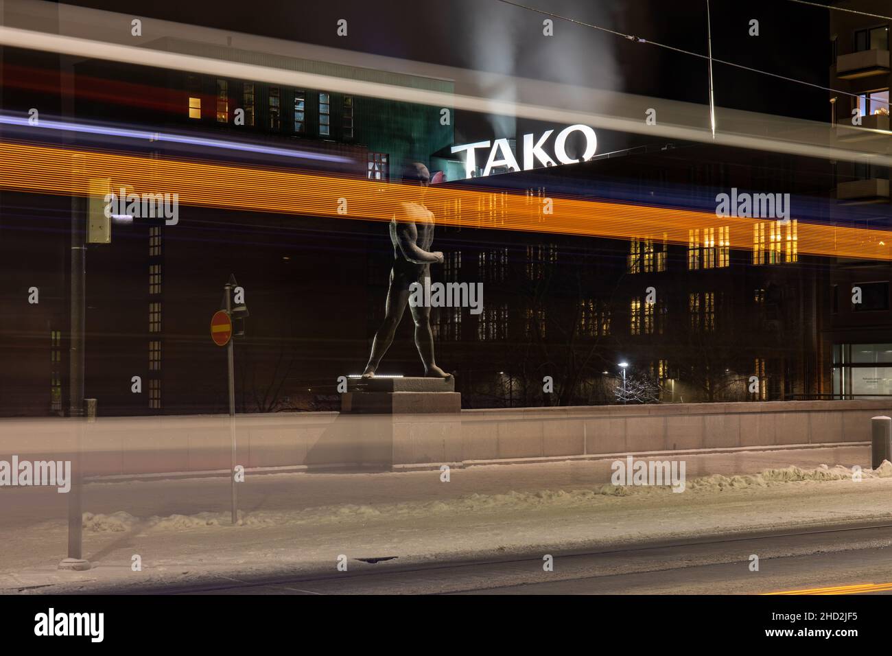 Hämeensilta with Tako board mill sign after dark, blurred by passing ...
