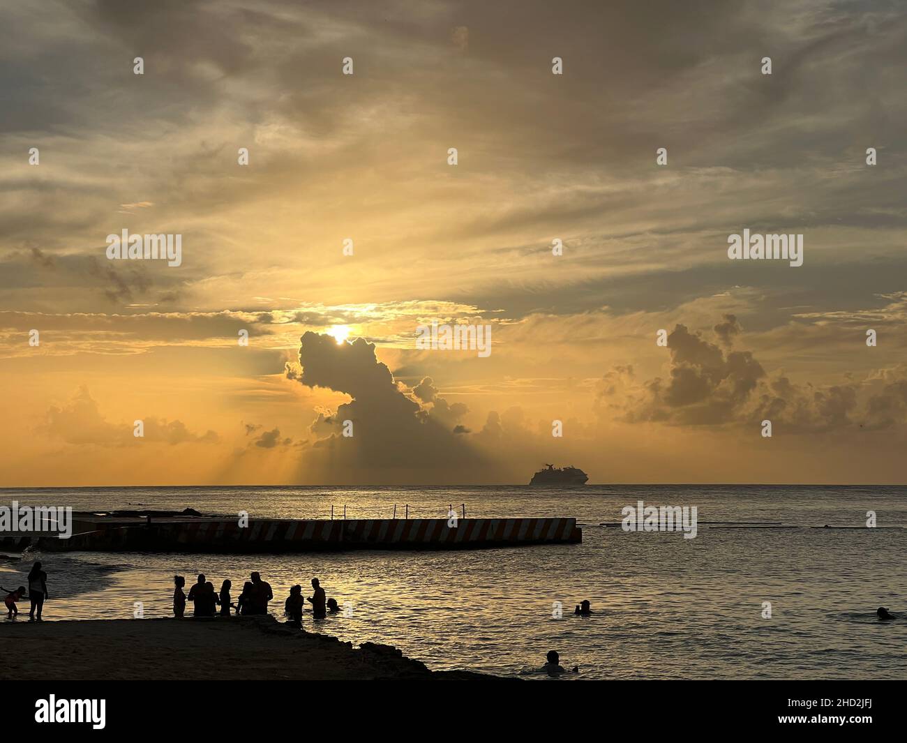 Silhouettes of people watching the sunset on Cozumel, Mexico. Big ...