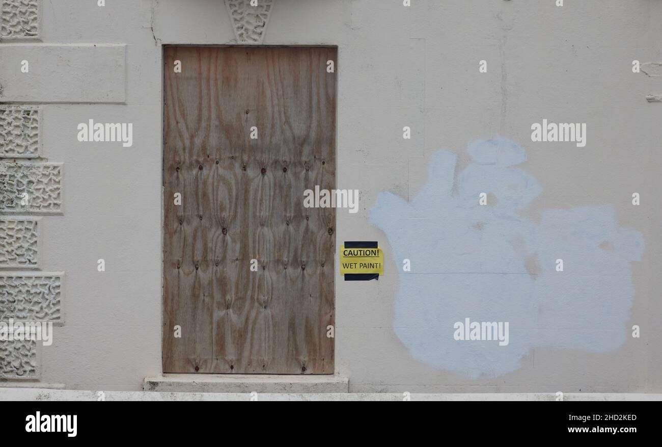Door boarded up on the side of a wall seen outdoors Stock Photo - Alamy