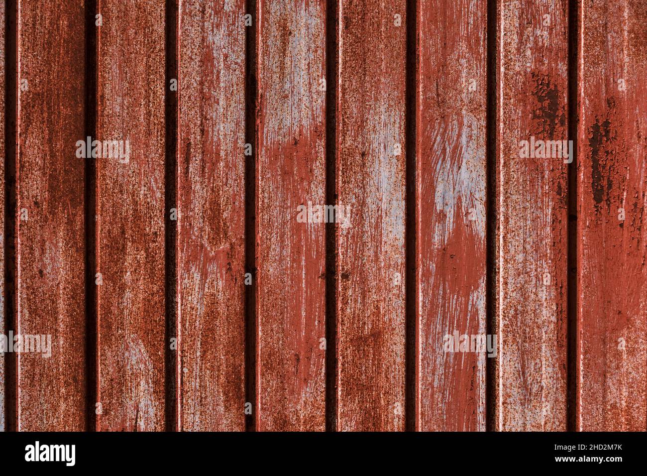 Old rusty metallic shutter with worn out red paint, grunge background ...