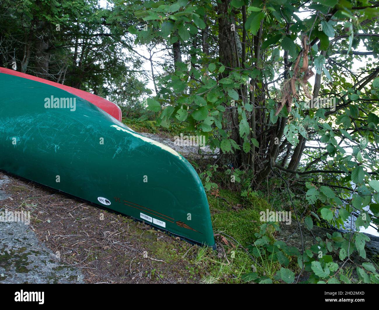 Two canoes beached on shore Stock Photo - Alamy