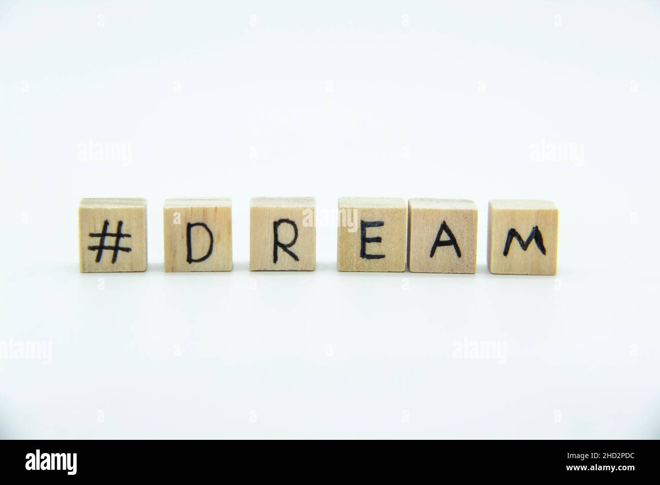 Word Dream written on the wood cubes on white background. The concept ...