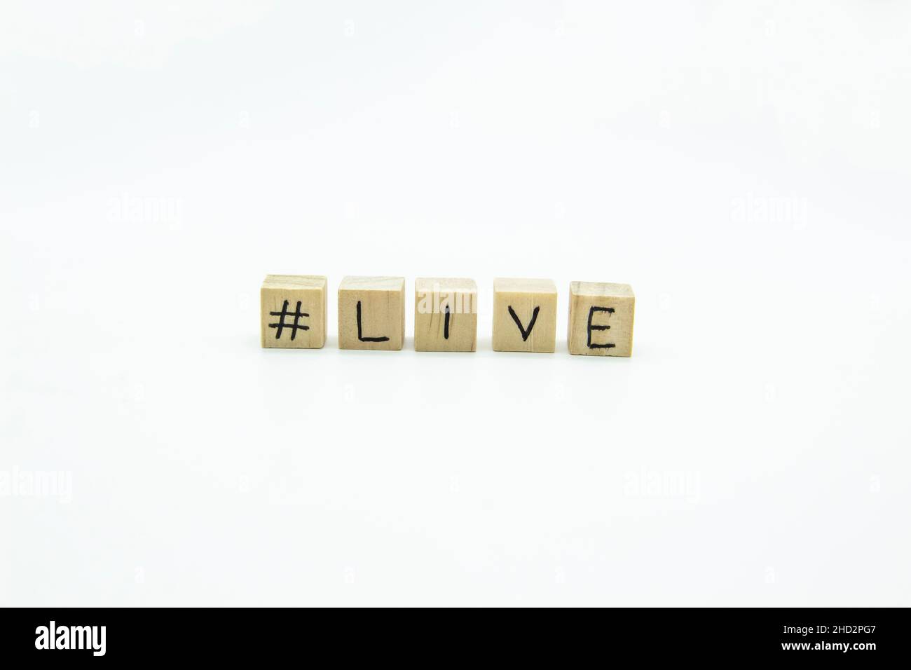 Word LIVE written on the wood cubes on white background. The concept ...